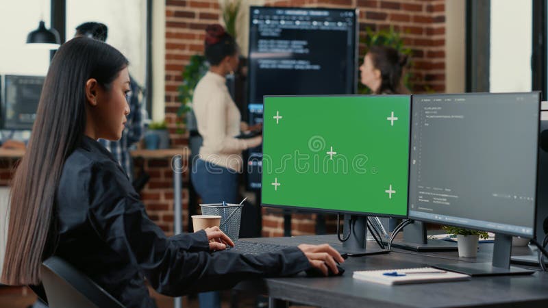 Asian Programer Writing Code In Front Of Computer With Green Screen Chroma Key Mockup Stock