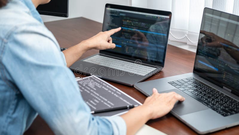 Asian Programmer Woman Pointing and Looking on Multiple Laptop Screen ... Asian Programmer Woman Pointing and Looking on Multiple Laptop Screen ...
