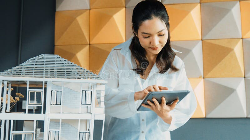 Asian Project Manager Using Tablet Check House Model. Manipulator ...