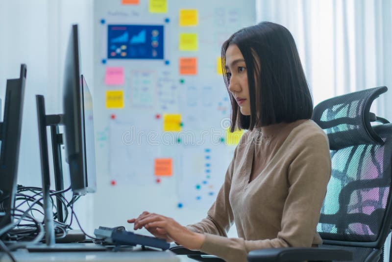 Asian Promt Engineer Develope Coding App With Software Data Sitting In Front Of Computer Monitor