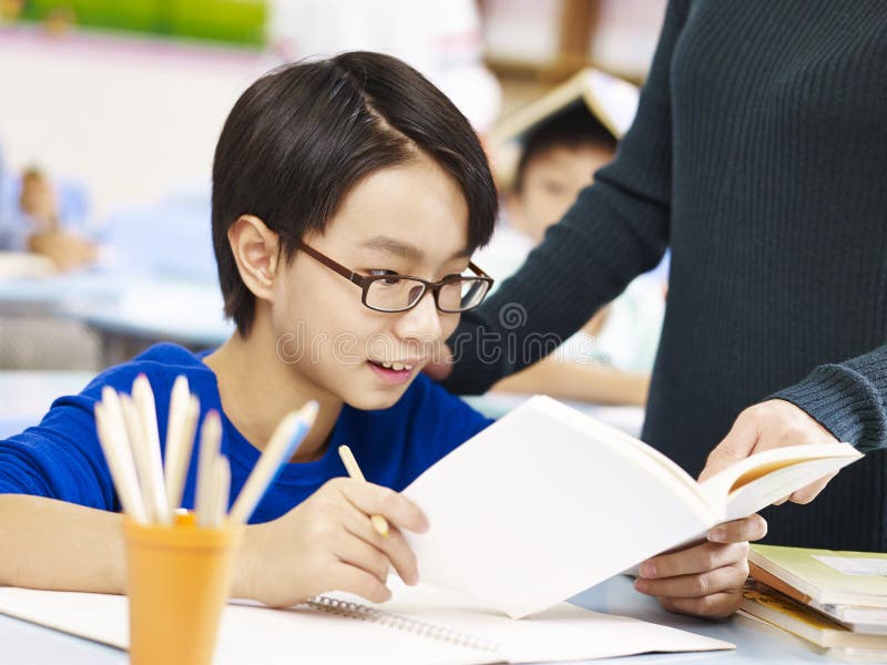 Asian Pupil Getting Help from Teacher Stock Photo - Image of asia ...