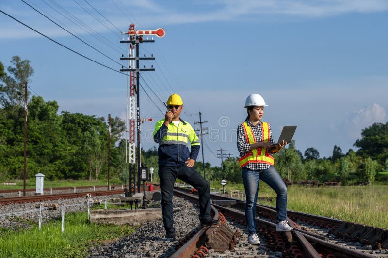 Asian Railway Engineer Inspects a Train Station Engineer Working on ...