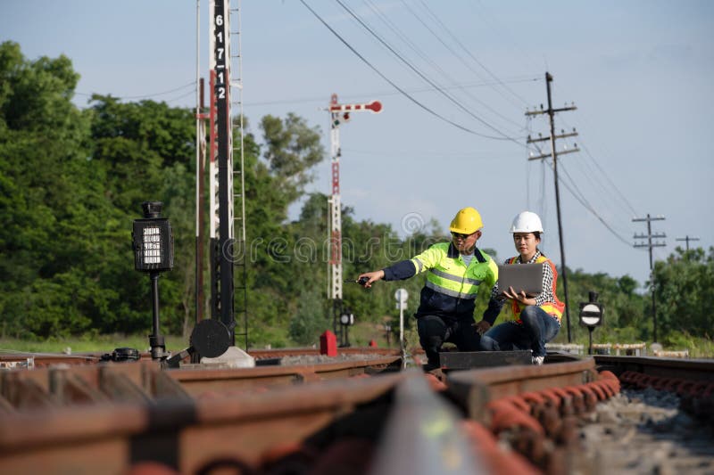 Asian Railway Engineer Inspects a Train Station Engineer Working on ...