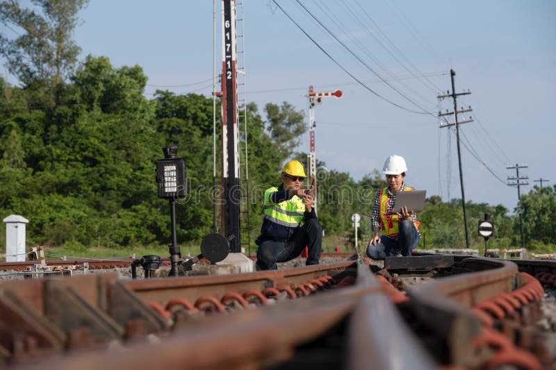 Asian Railway Engineer Inspects a Train Station Engineer Working on ...