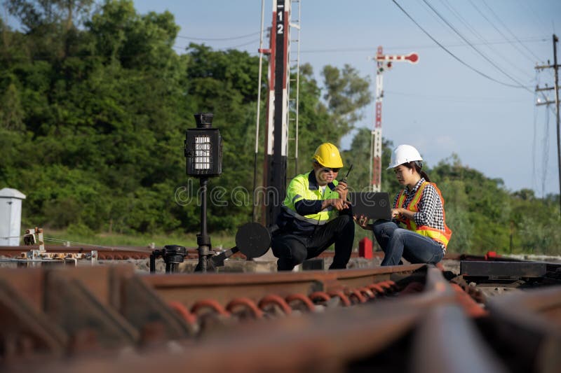 Asian Railway Engineer Inspects a Train Station Engineer Working on ...