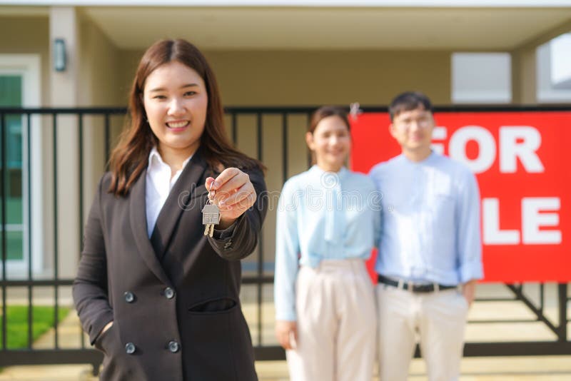 Asian Real Estate Agent Or Realtor Woman Smiling And Holding Red File With Showing House Key