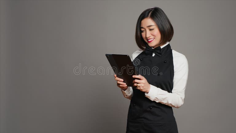 Asian Restaurant Server Checking All Table Reservations on Tablet Stock ...