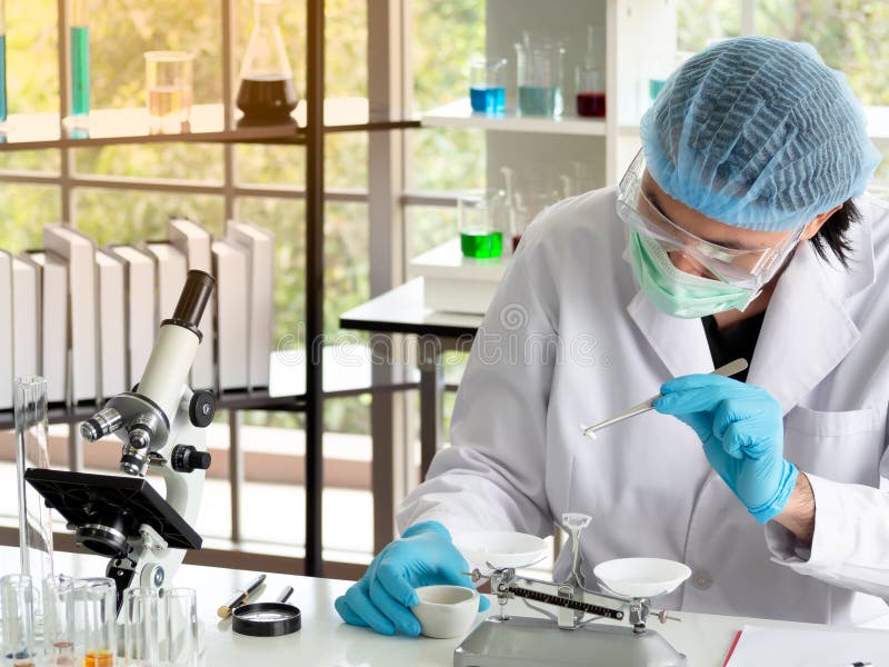 An Asian Scientist or Chemist Looking at a Pill and Using Mechanical ...