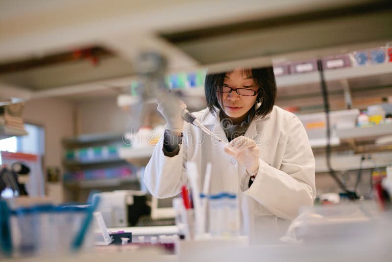 Asian Scientist Pipetting at a Biomedical Laboratory Stock Image ...