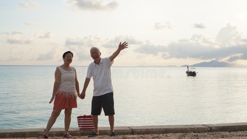 Asian Senior Elder Couple Relax Enjoy Have Fun On Tropical Seaside