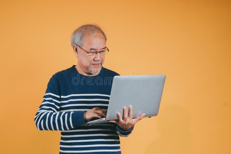 Asian Senior Man Using Laptop Computer for Working after Retirement on ...