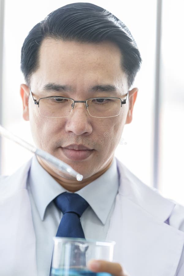 Asian Senior Scientist Researching and Learning in a Laboratory Stock ...