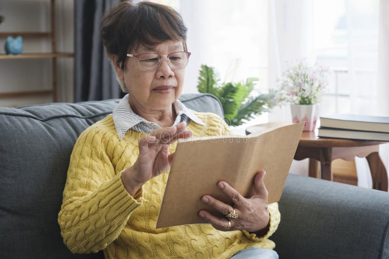 Asian Senior Woman Immersed in the Pleasure of Reading at Home Stock ... Asian Senior Woman Immersed in the Pleasure of Reading at Home Stock ...