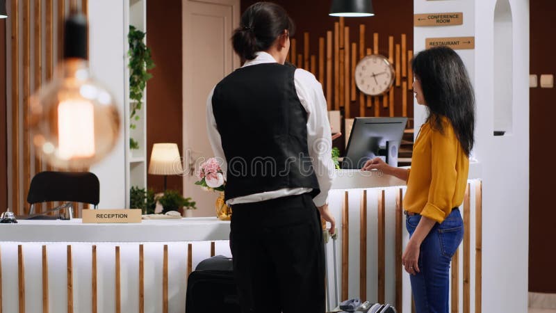 Asian Staff Doing Check in Process for New Customer Stock Footage ...