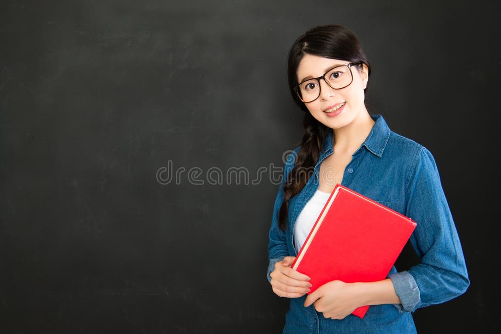 Asian Student Bring a Book Standing in Front of Chalkboard Stock Photo ...