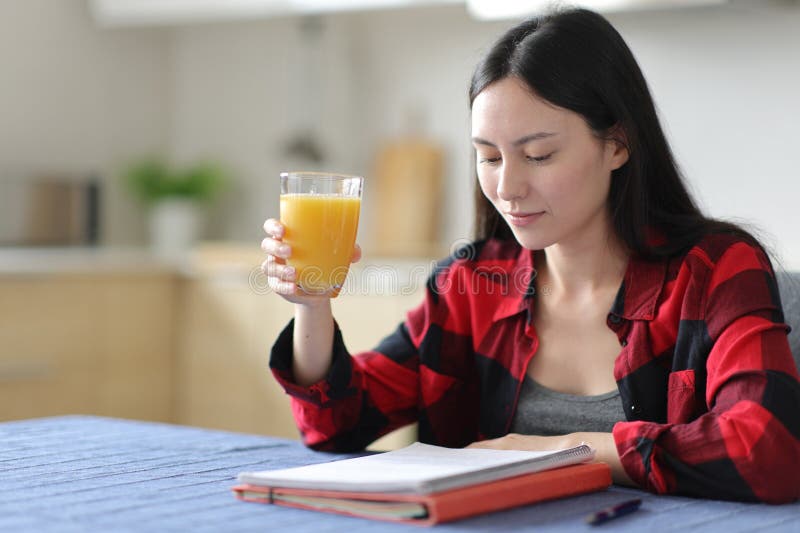 Asian Student Holding Orange Juice Studying Kitchen Stock Photos - Free ...