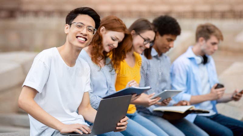 Asian Student Learning with Coursemates Sitting Outside University ...