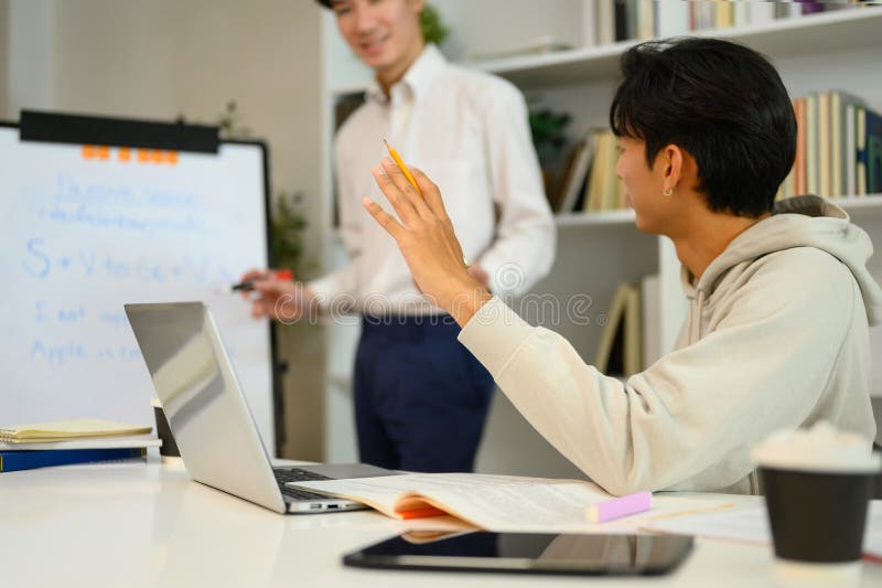Asian Student Man Asking a Question while Tutor Explaining Something on ...