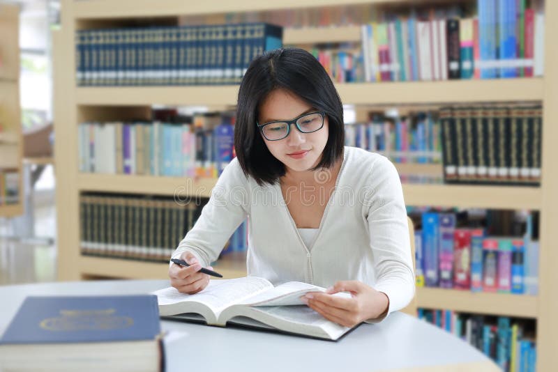 Asian Student Reading Book in the Library at University Stock Image ...