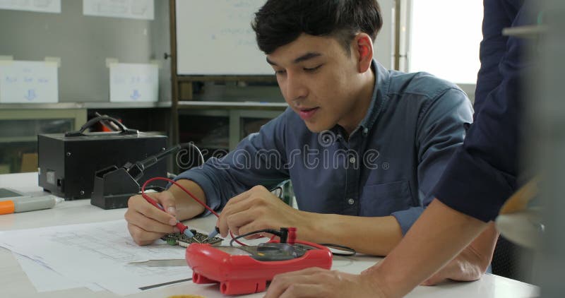 Asian Young Electronics Engineer Building, Fixing Robotics in ...