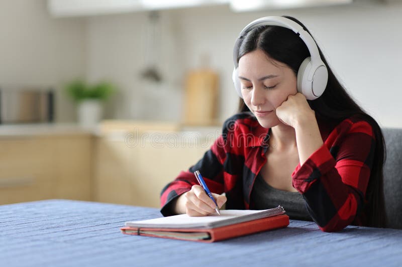 Asian Student Witgh Headphone Taking Notes in the Kitchen Stock Image ...