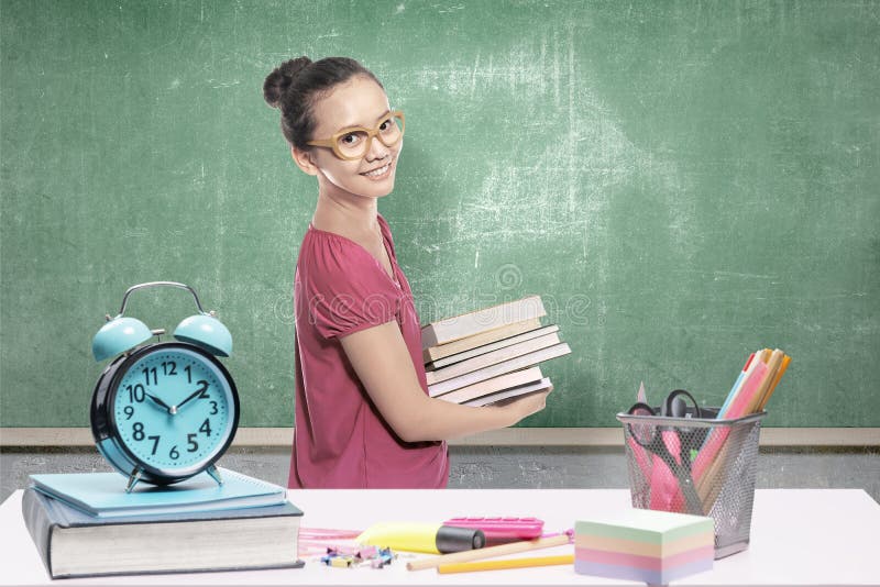 Asian Student Woman Carrying a Stack of Books in the Classroom Stock ...
