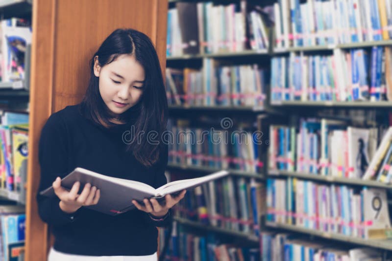 Asian Students Reading Books in the Library. Stock Photo - Image of ...