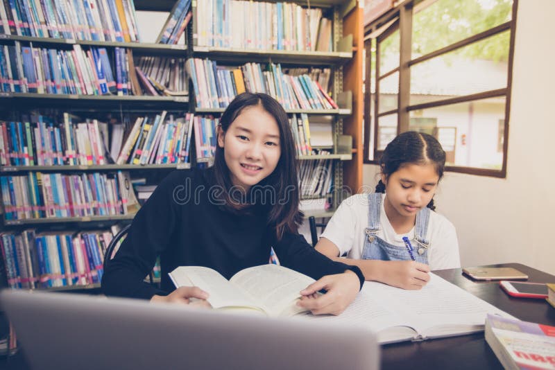 Asian Students Reading Books in the Library. Stock Photo - Image of ...