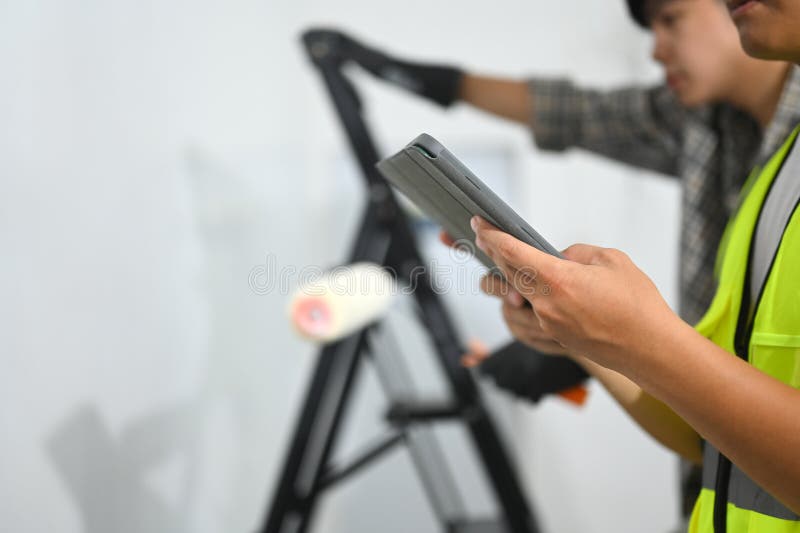 Asian Supervisor with Digital Tablet Overseeing Painting Work at ...