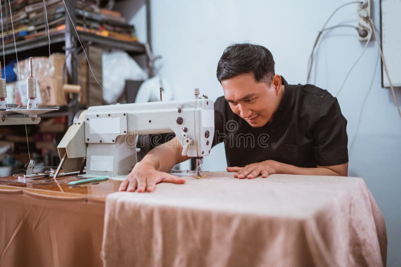 Asian Tailor Sewing the Fabric Using the Sewing Machine Stock Photo ...