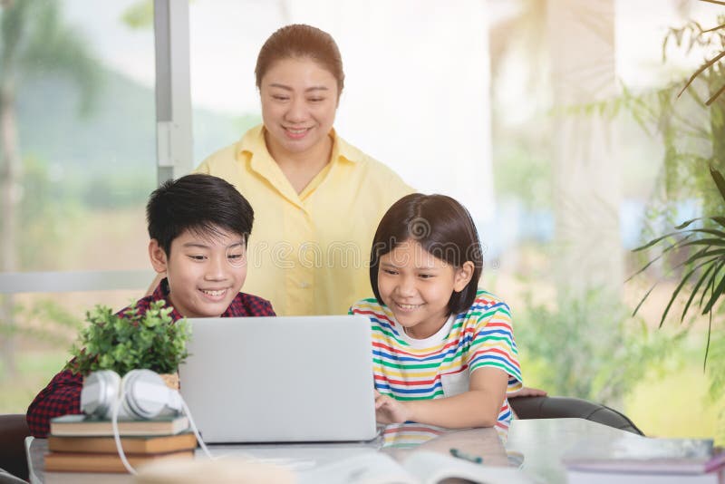 Asian Teacher and Kids Entertaining Using Laptop Computer. Stock Photo ...