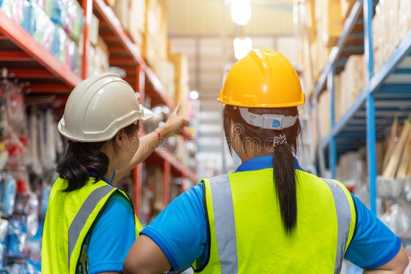 Asian Teamwork of Warehouse Workers Wearing Hard Hat Holding Digital ...
