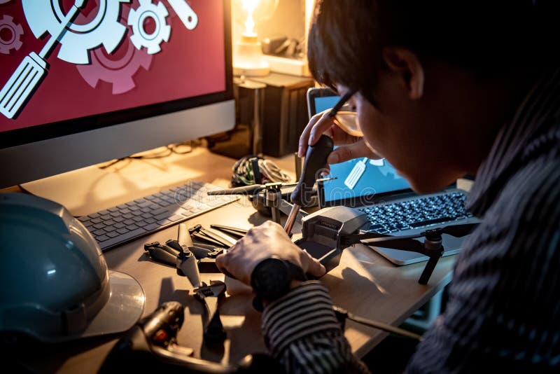 Asian Technical Engineer Using Screwdriver for Repairing Drone Stock ...