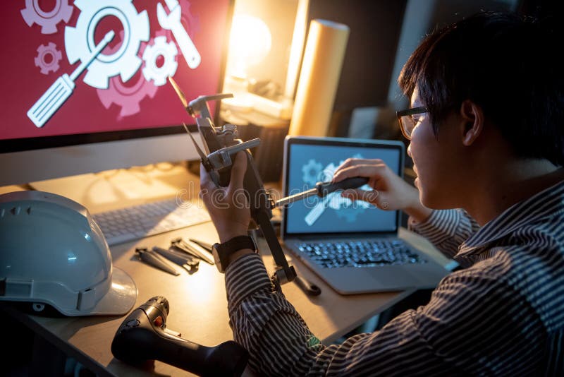 Asian Technical Engineer Using Screwdriver for Repairing Drone Stock ...