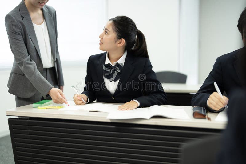 Asian Teenagers in High School Uniforms Studying in Class with Teacher ...