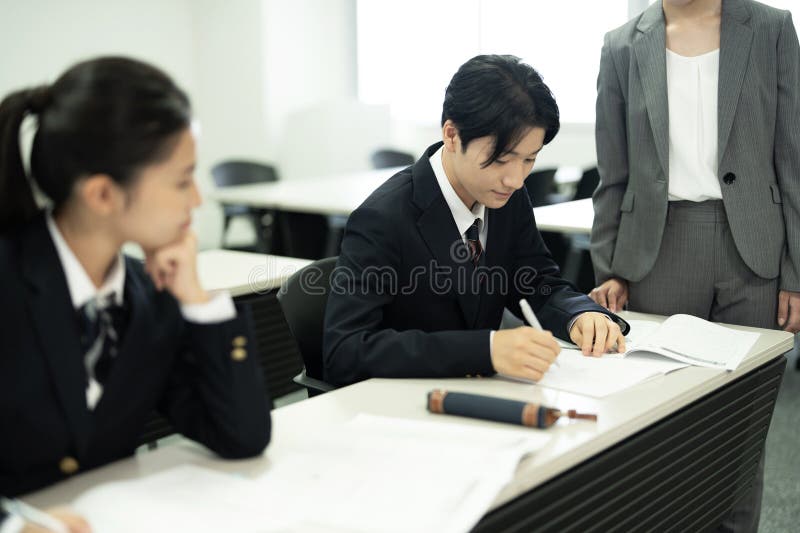 Asian Teenagers in High School Uniforms Studying in Class with Teacher ...