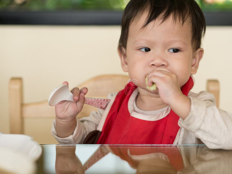 Asian Toddler Learn To Eat Meal Herself. Stock Photo - Image of ...