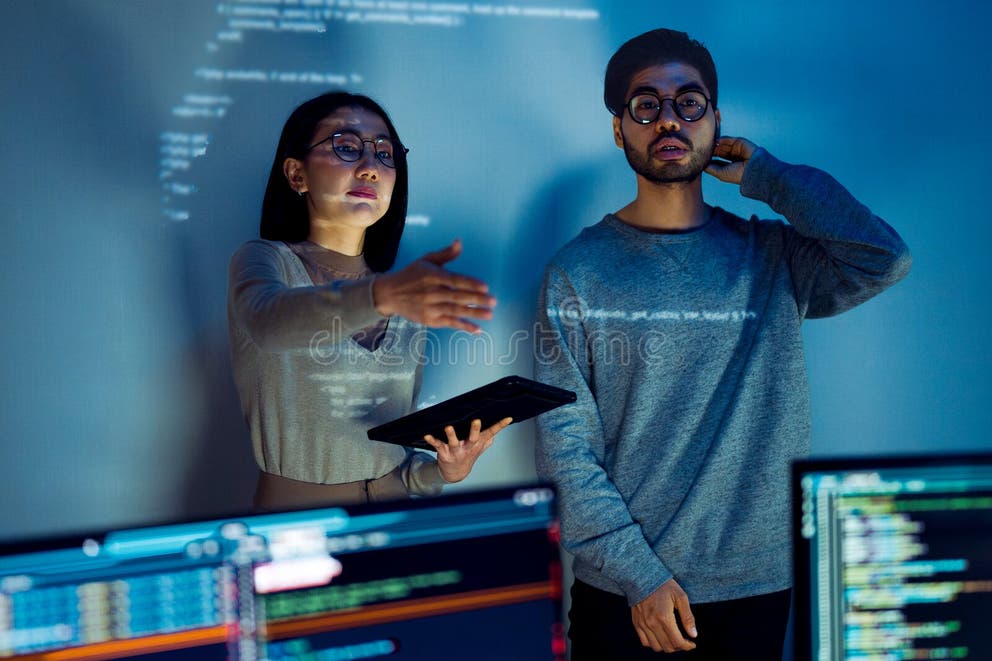 Asian Two Software Developers Engaged in Collaborative Coding Session, with Code Projected Onto ...