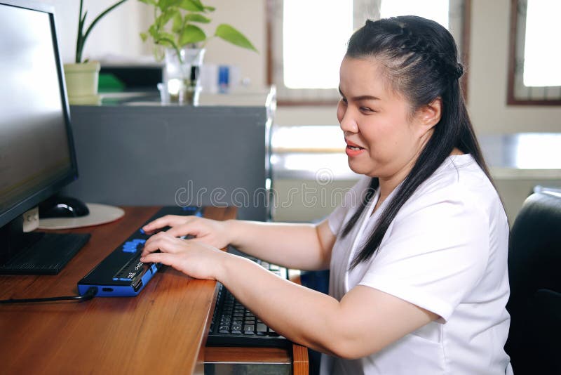 Asian Woman with Blindness Disability Using Computer with Refreshable ...