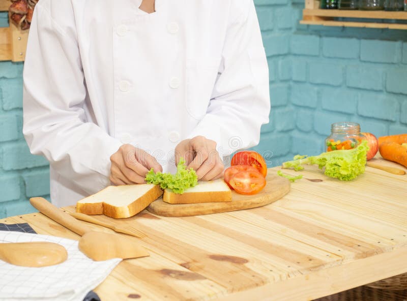 Asian Woman in Chef`s Uniform is Cooking in the Kitchen Stock Image ...