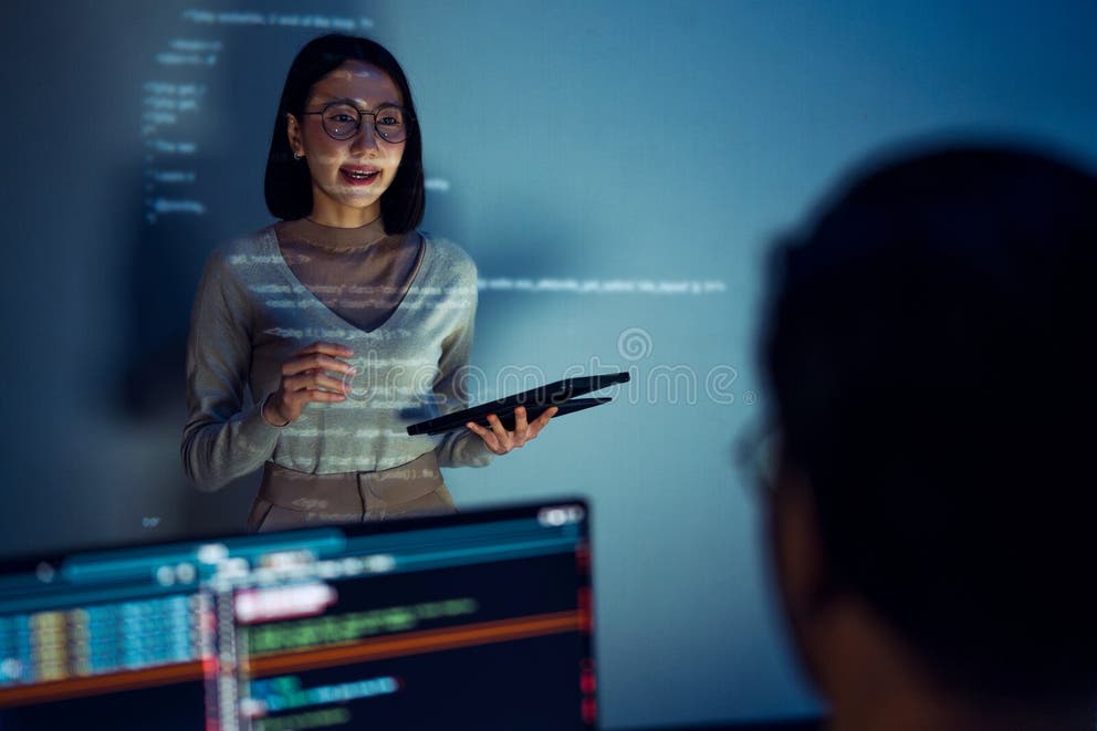 Asian Woman Developers Collaborating on a Coding Project, with One ...
