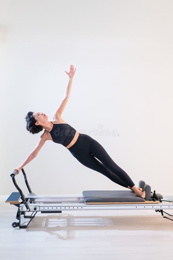 Asian Woman Doing Pilates on Reformer. Stock Image - Image of alignment ...