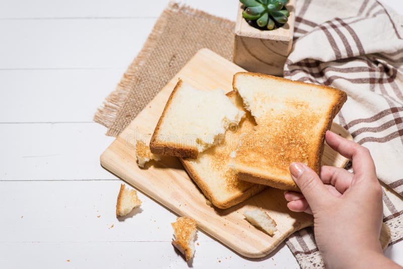 Asian Woman Eating Bread for Breakfast. Focus on Hands. Stock Image ...