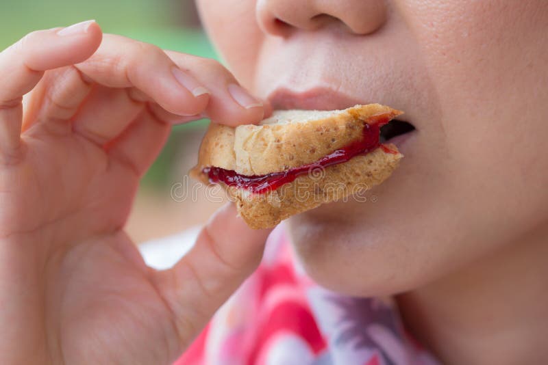 Asian woman eating bread stock photo. Image of young - 43703134