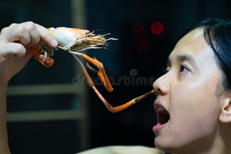 Woman eating large shrimp stock image. Image of hand - 185145669