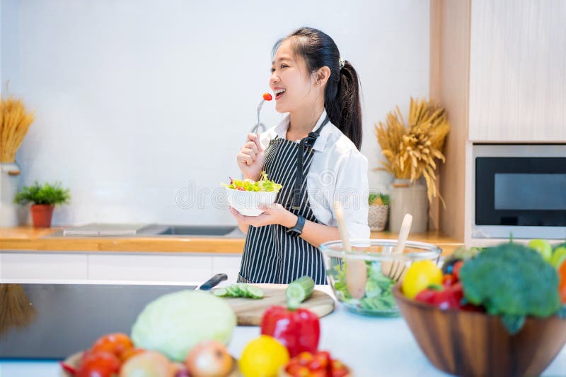 Asian Woman Eating A Salad In The Kitchen Stock Image Image Of Lady