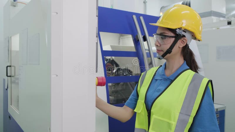 Engineer Operating Control Panel in Industrial Setting with Focused ...