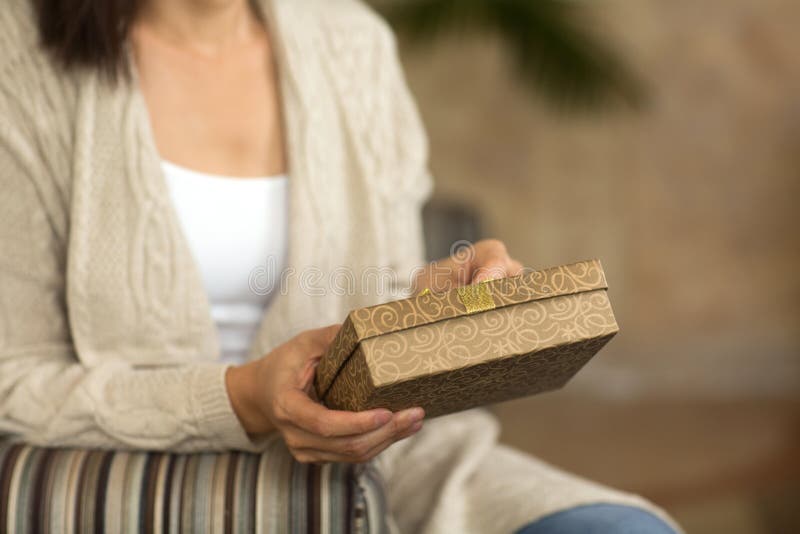 Asian Woman Holding a Gift Sitting on the Sofa. Stock Photo - Image of ...