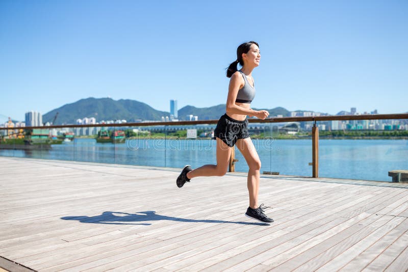 Asian Woman Jogging on the Boardwalk Stock Photo - Image of people ...