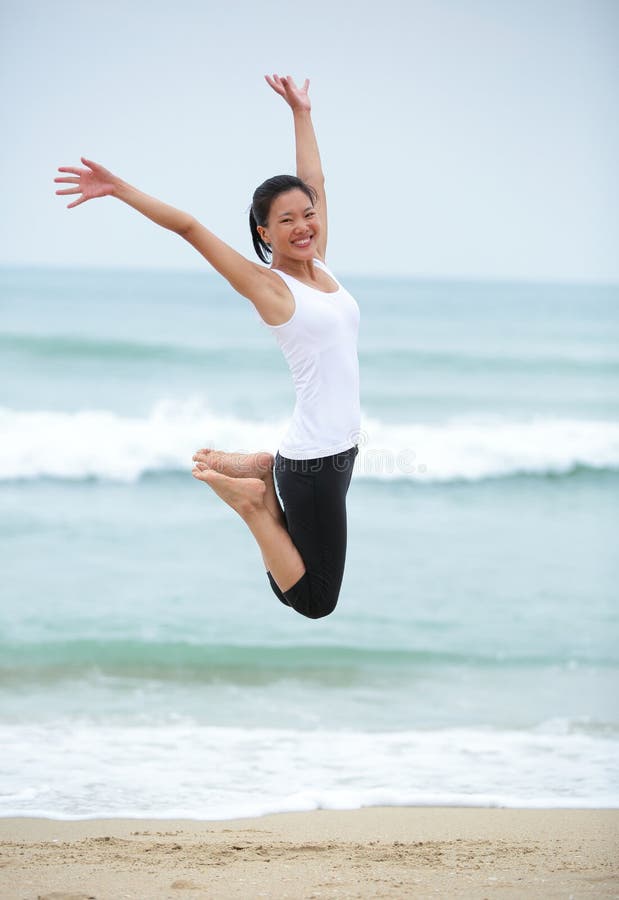 Asian woman jump on beach. stock photo. Image of happy - 37930092